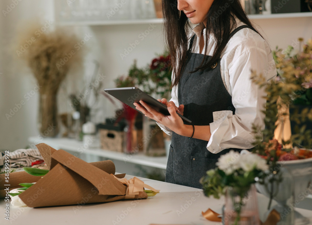 Florist Using Tablet At Flower Shop Stock Photo | Adobe Stock