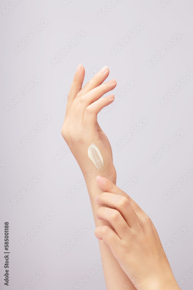 Beautiful woman's hand applying cream on back of hand, applying lotion ...