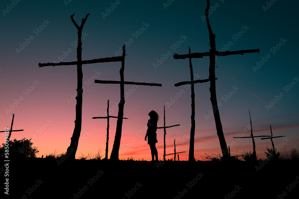 Standing silhouette at surreal wood crosses field Stock Photo | Adobe Stock
