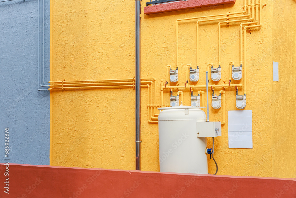 Gas installations installed on the wall of a yellow building. Stock ...