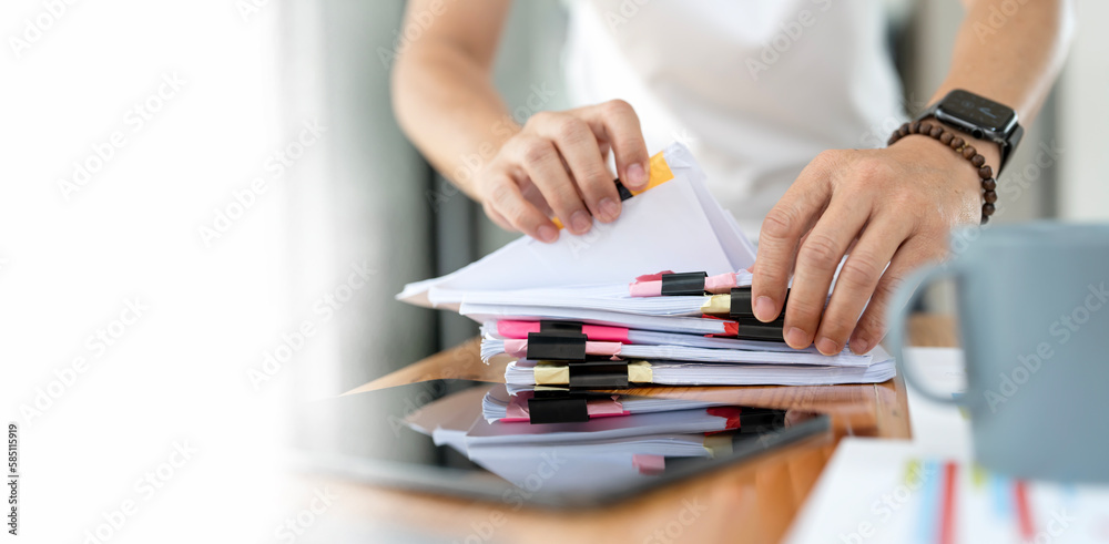 Businesswoman hands working in Stacks of paper files for searching and ...