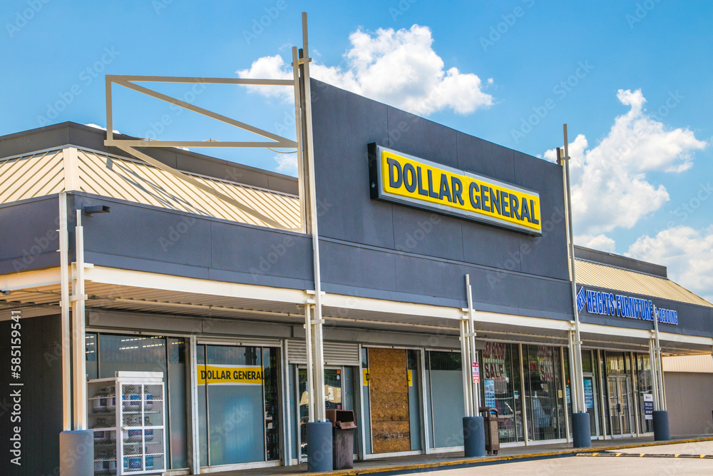 Dollar General retail store entrance and sign with boarded up windows ...