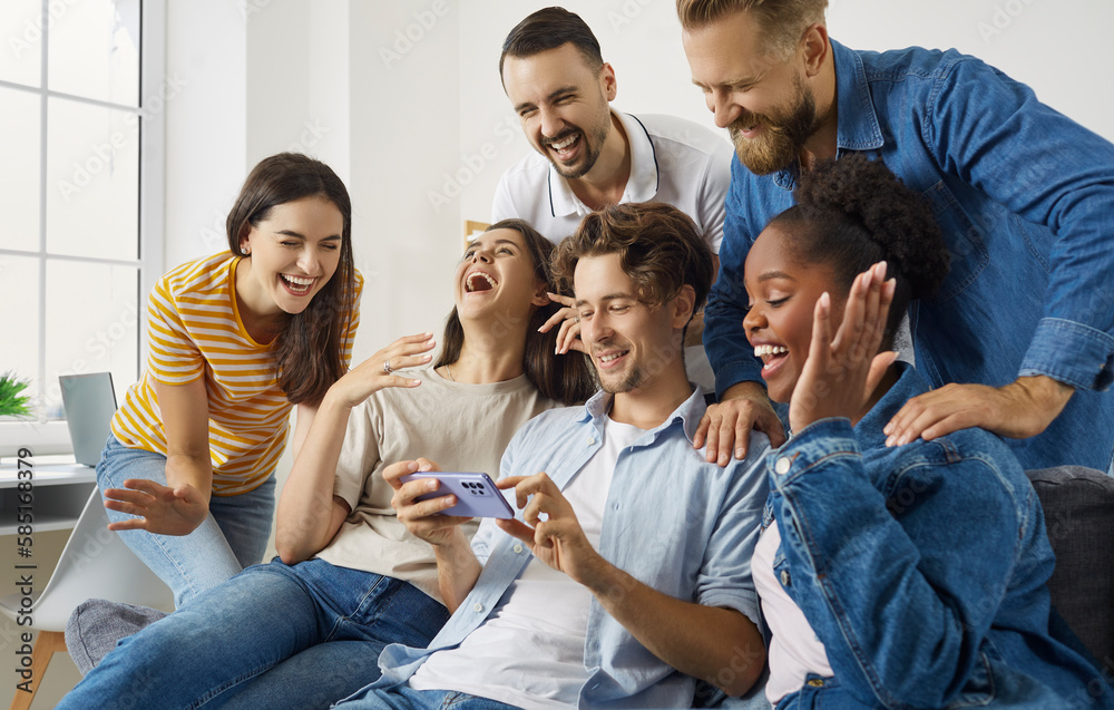 Cheerful friends watching something very funny on mobile phone. Group ...