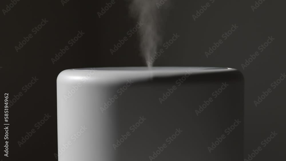 Modern white air purifier and humidifier releases strong stream of cold ...