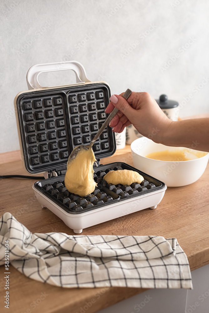 The process of making homemade Belgian (Viennese) waffles. A woman's ...