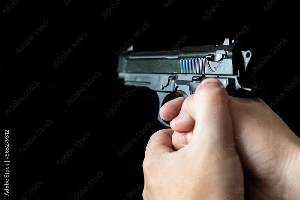Hand holding a gun, on black background. concept of the crime of ...