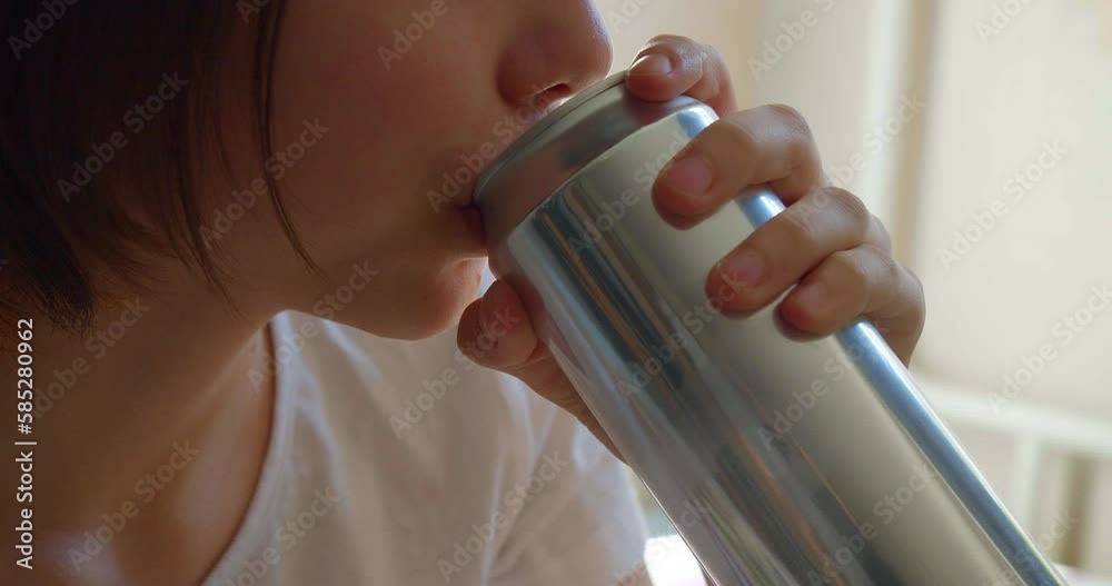 Teenage girl drinking energy drink from can. Stock Video | Adobe Stock