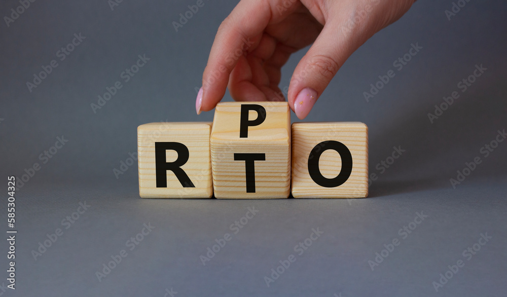 RPO vs RTO symbol. Businessman hand turns wooden cubes and changes the ...