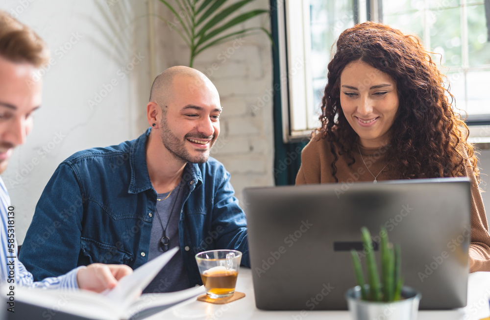 A group of friends collaboratively studying for exams in a library ...