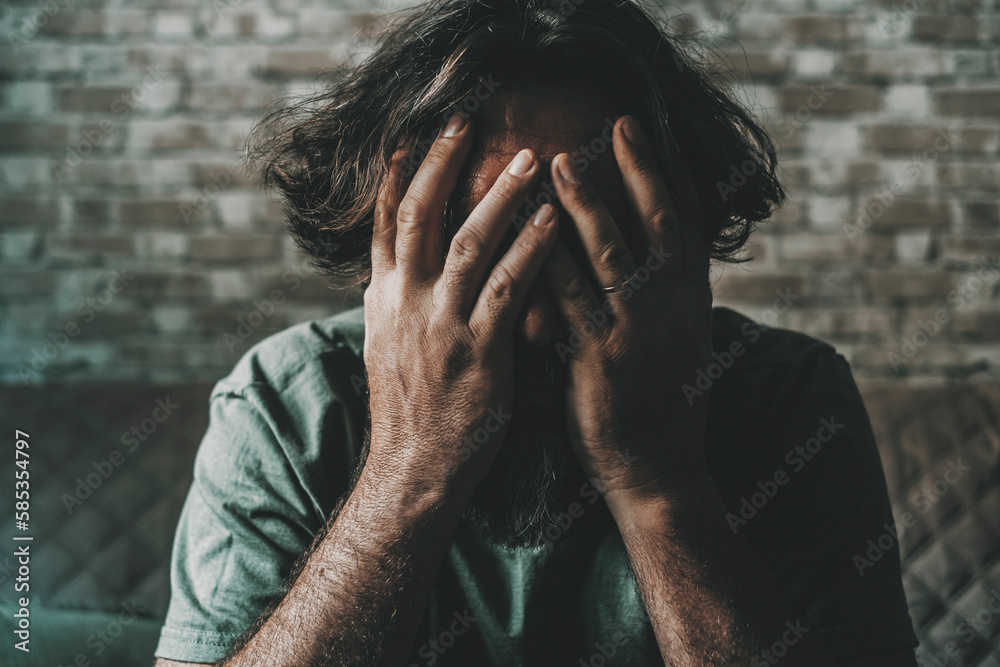 Closeup portrait scene of desperate man indoor at home sitting on the ...