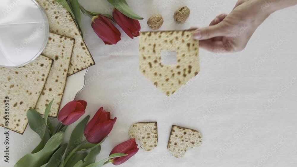 Matzah shape of heart with red tulips, bottle of wine and walnut on ...