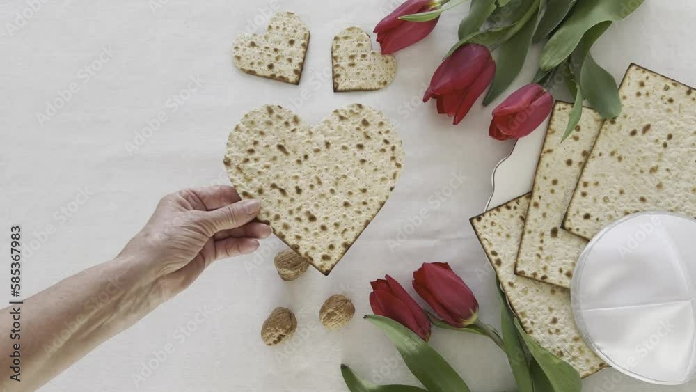 Matzah shape of heart with red tulips, kipa and walnut on white ...