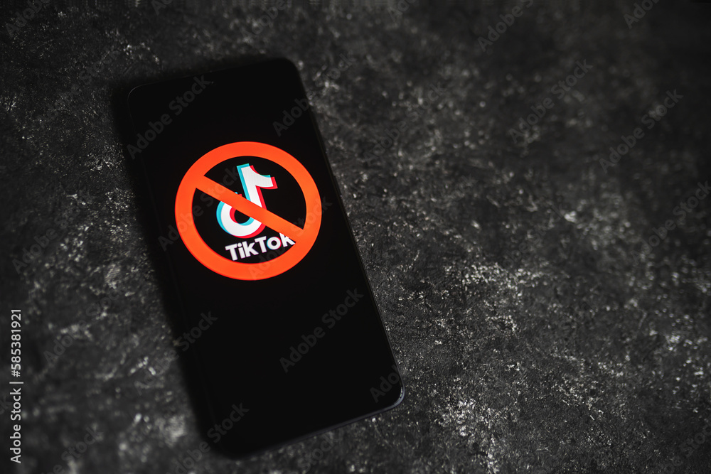TikTok app logo crossed out with red Ban sign displayed on phone screen ...
