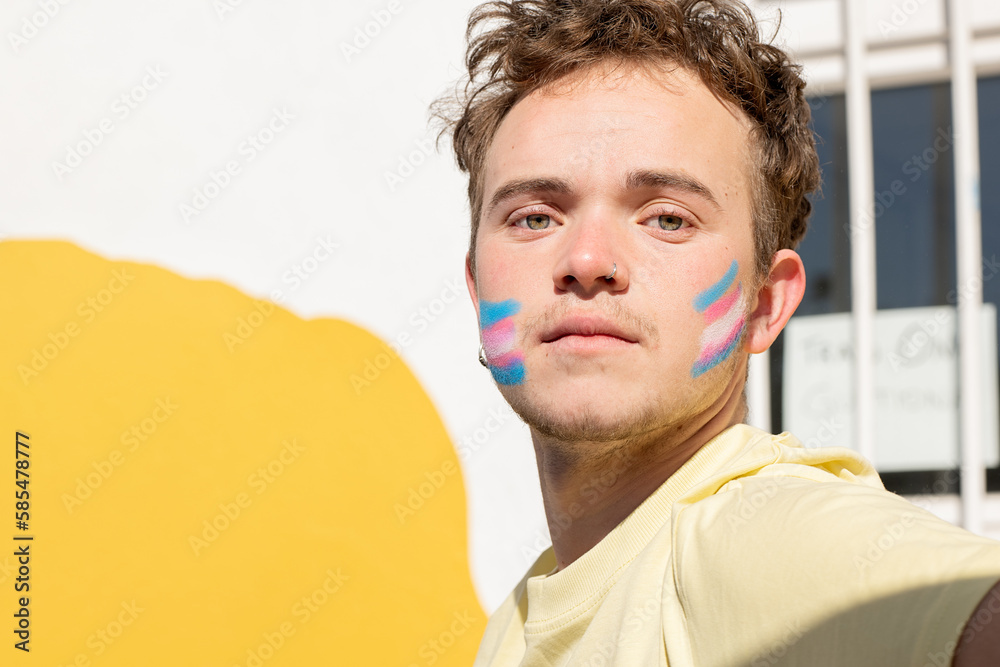 transgender man with transgender flag painted on his face Stock Photo ...