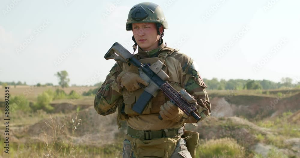 Portrait of military man in army helmet standing and looking around ...