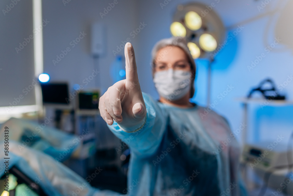 Female proctologist wearing medical uniform is posing showing fingers ...
