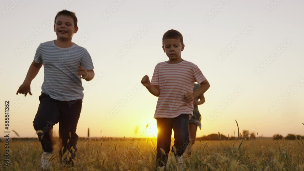 Child is running. Children run on grass, sunset. Child plays outdoors ...