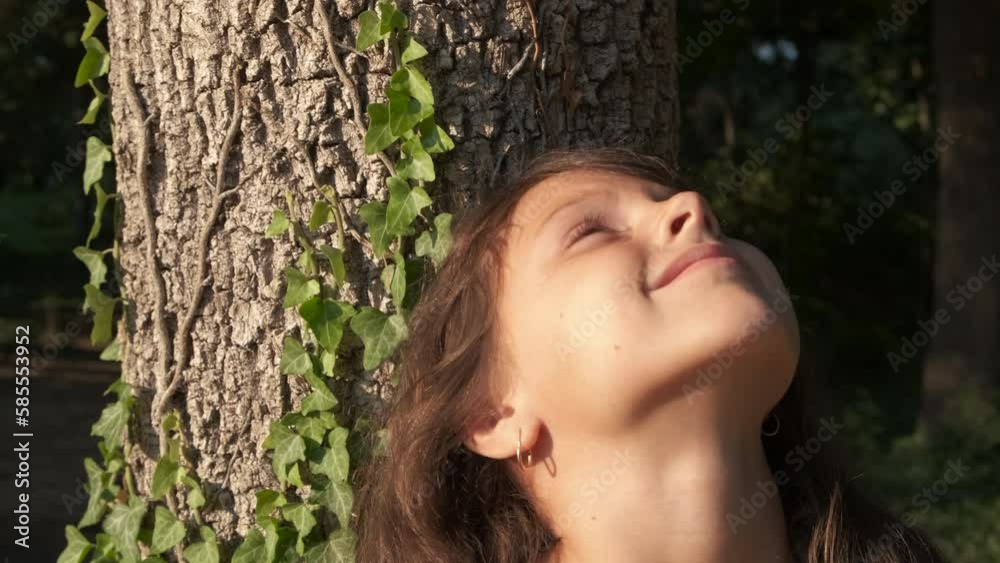 Healthy child time among trees. A view of healthy girl stay by the tree ...