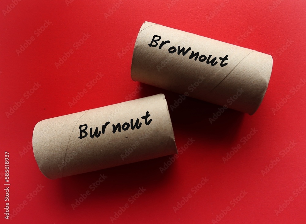 Toilet paper roll on red background with handwritten text BROWNOUT and ...