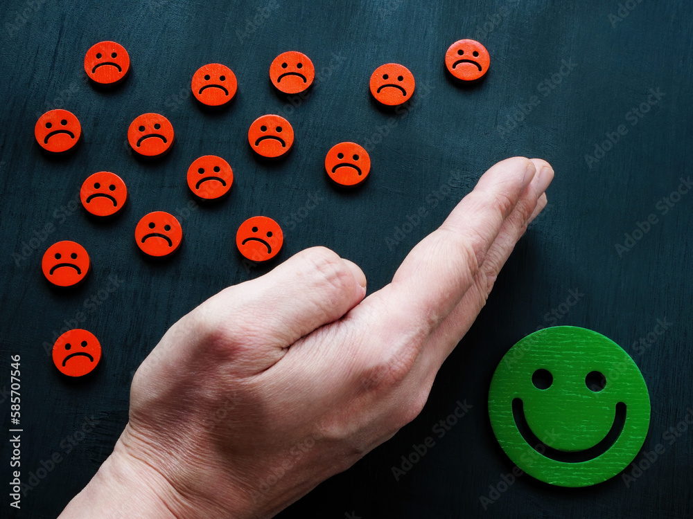 The hand protects the joyful emoticon from the sad ones. Emotional ...