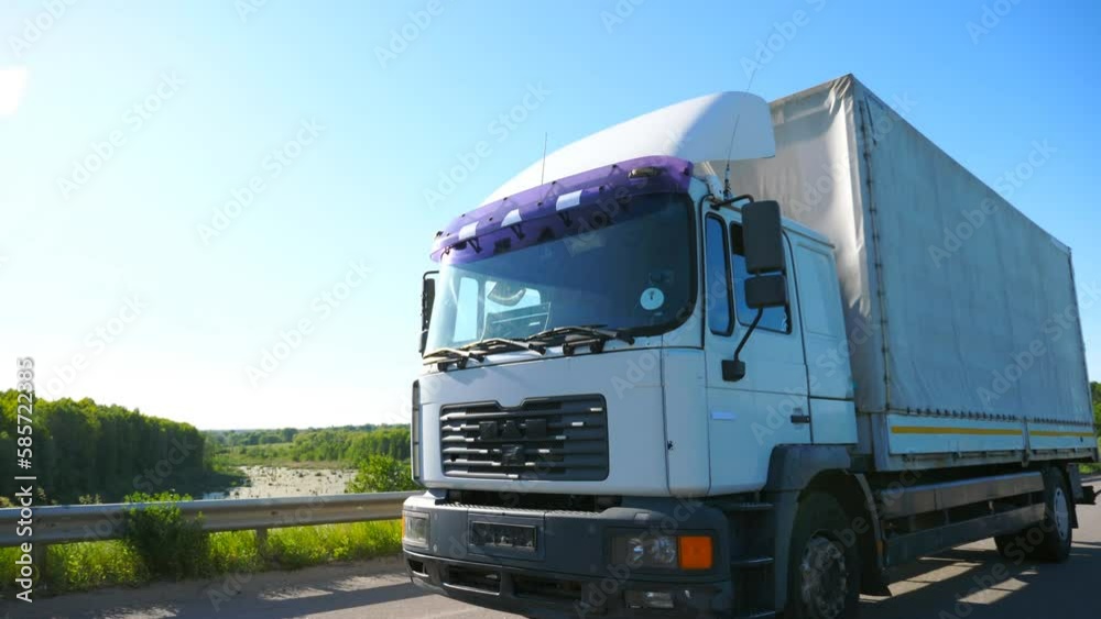 Big truck with cargo trailer driving on highway and transporting goods ...