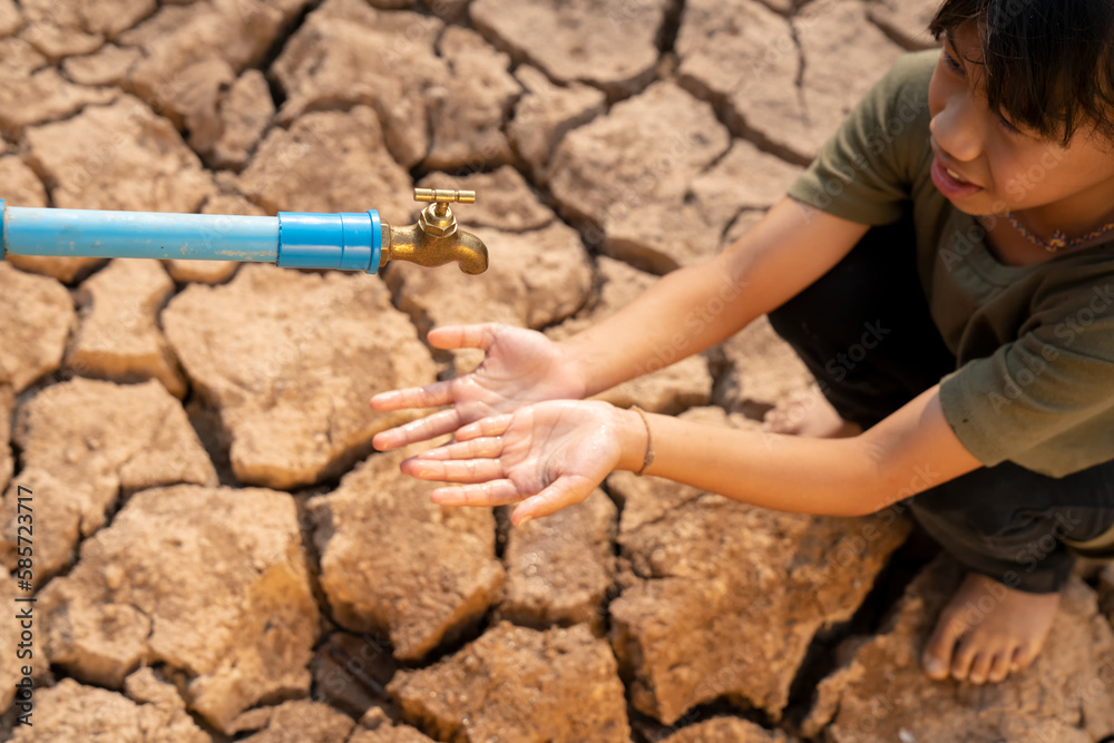 Sad kids are sitting on cracked earth open metal water old faucet on ...