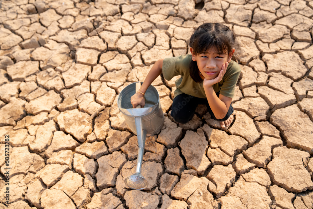 Sad kids are sitting on cracked earth open metal water old faucet on ...