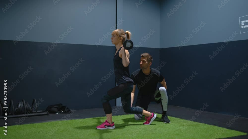 A young couple trains in the gym doing modern exercises to improve ...