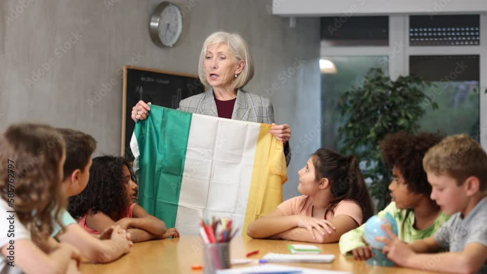 Kids learning together about ireland in geography class Female teacher ...
