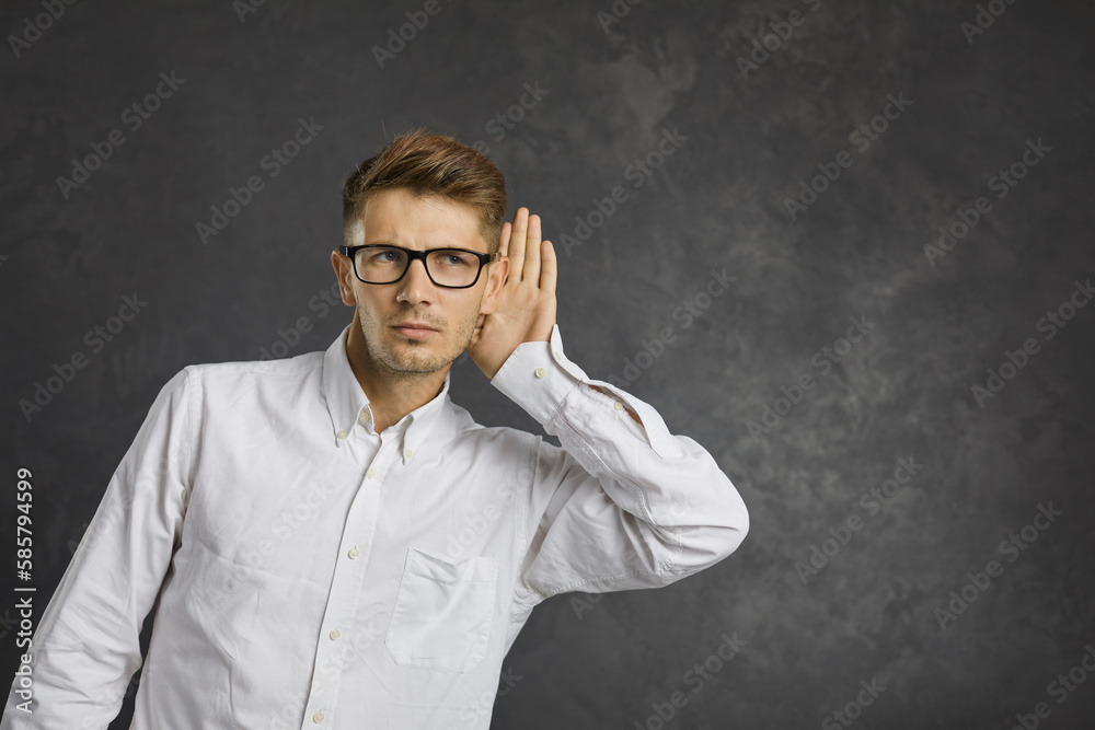 Millennial Caucasian man on black studio background make hand gesture ...