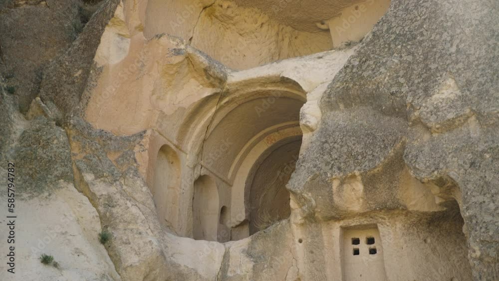 Ruined rock with a cave city inside. Camera moves from top to bottom ...