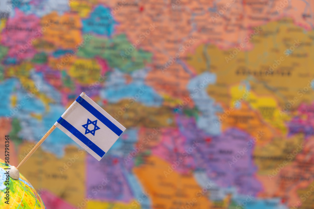 The flag of Israel on the background of a blurry map is out of focus ...
