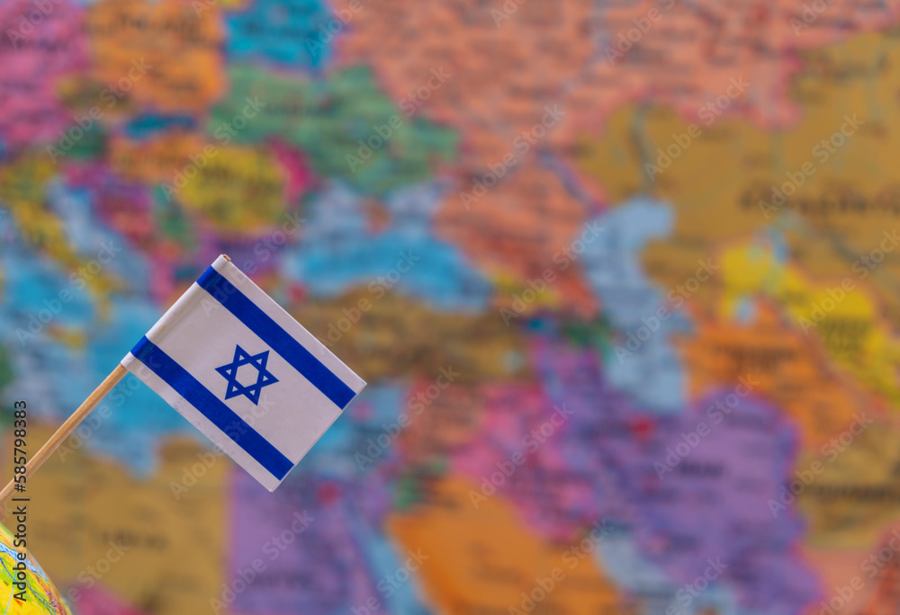 The flag of Israel on the background of a blurry map is out of focus ...