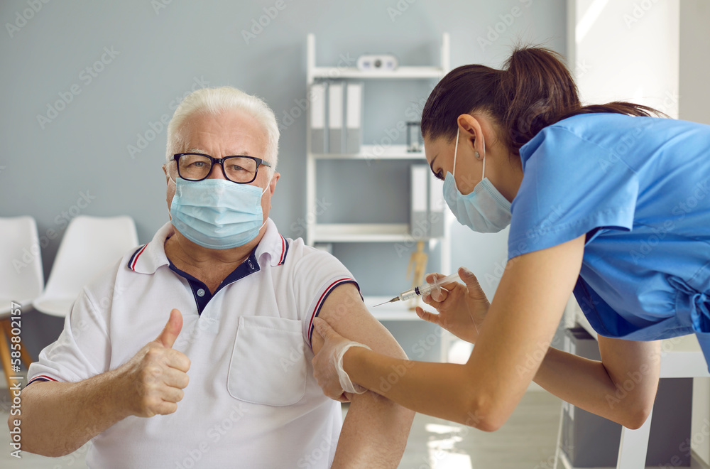 Senior man in face mask getting vaccine shot in hand in hospital. Nurse ...