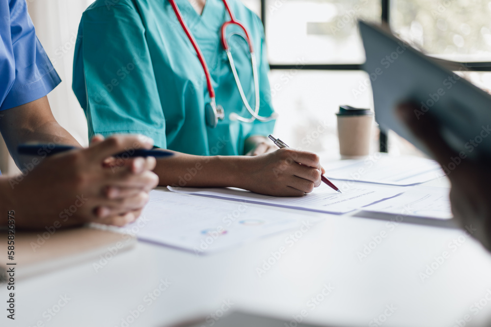 Team, medical analysts and doctors consulting with paperwork of graphs ...