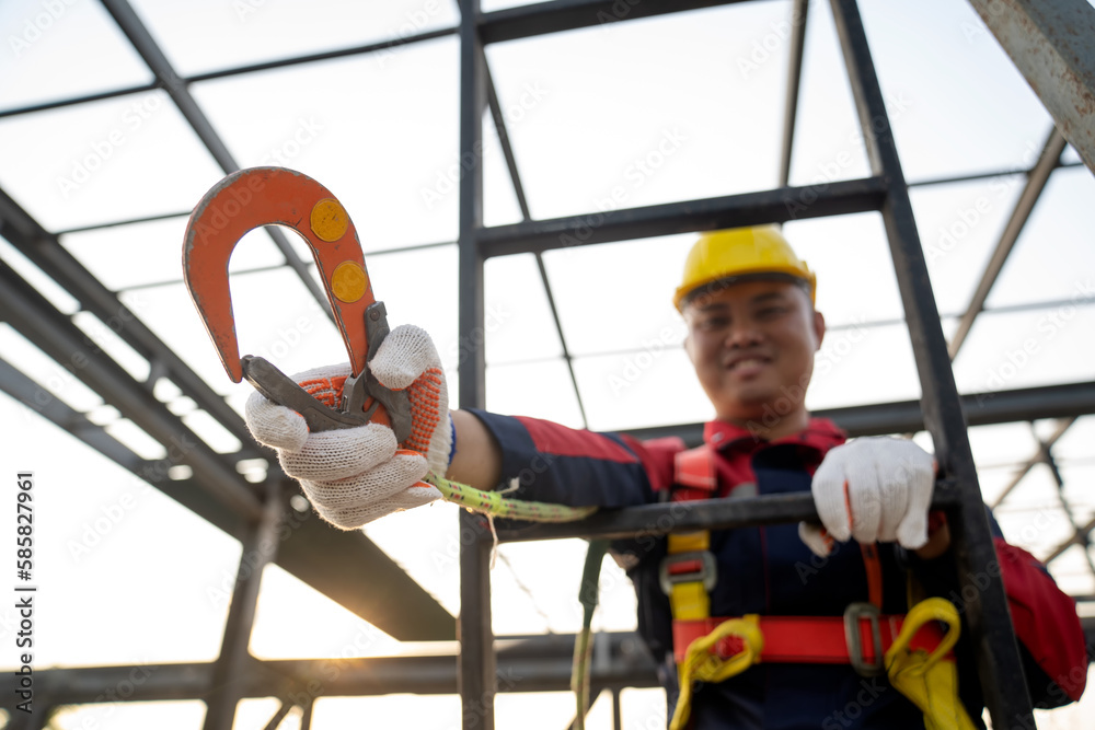 Construction worker use safety harness and safety line working on a new ...