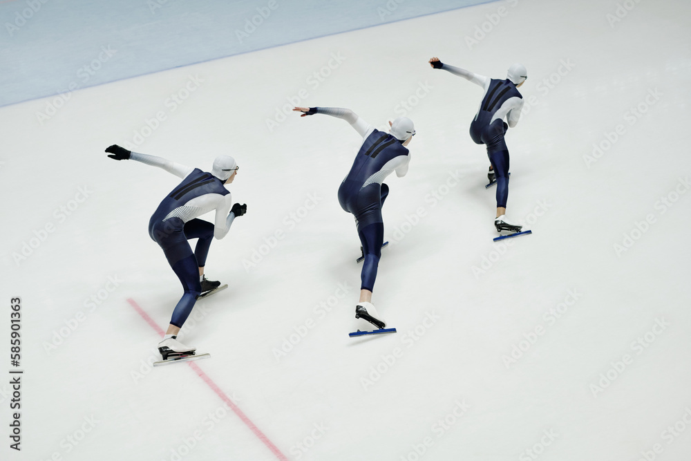 High angle of three young men in sports uniform and skates moving ...