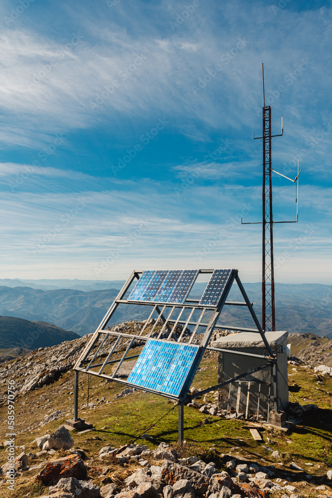 installation of solar panels on a mountain peak on a sunny day. green ...