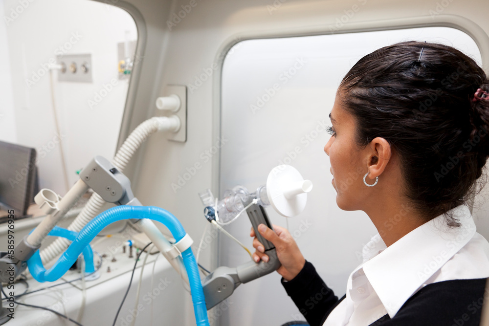 Foto de Young woman during a spirography test, measuring breathing ...