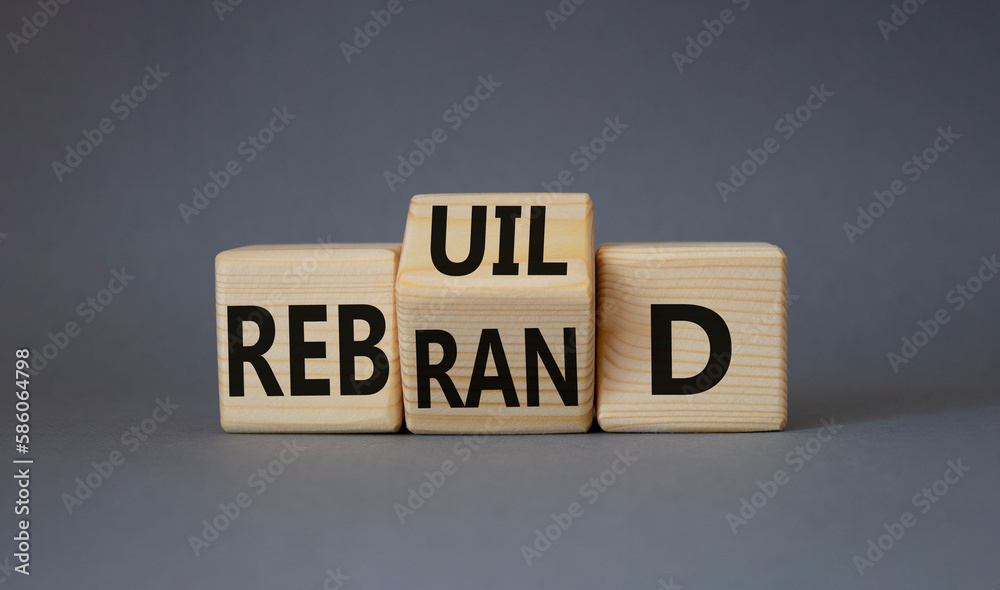 Rebuild and Rebrand symbol. Turned wooden cubes with words Rebrand and ...