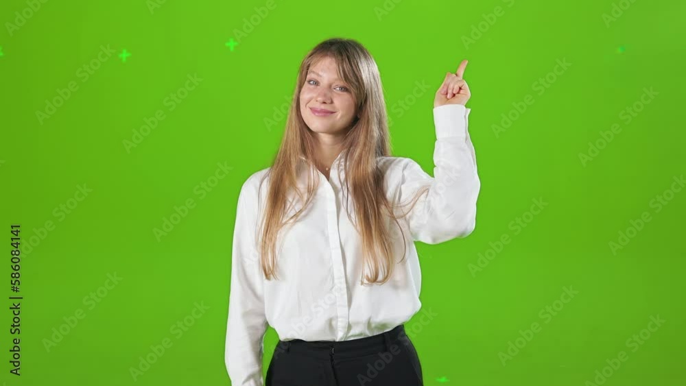 Front view of smiling woman standing in studio, looking at camera ...
