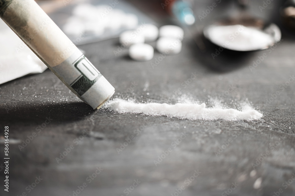 Snorting cocaine, white powder line, rolled up dollar bill, white pills ...