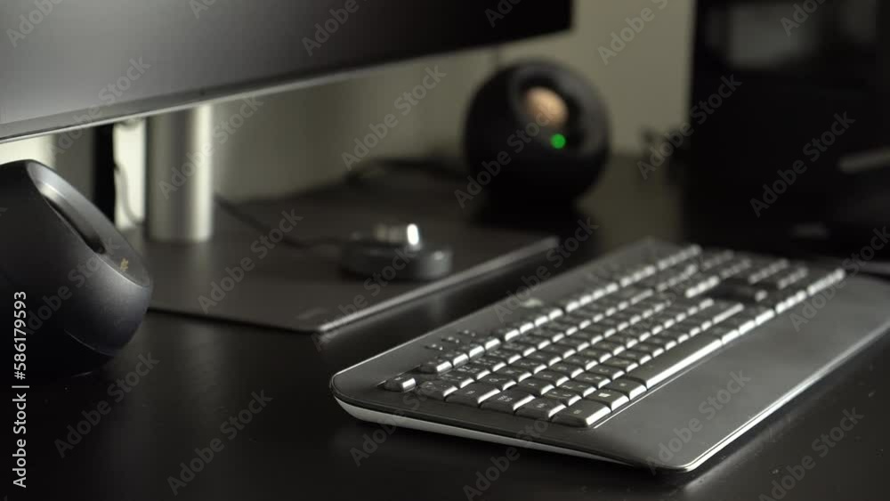 A desktop computer setup on an office table - speakers and a keyboard ...
