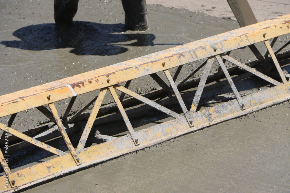 This impressive photo showcases a vibratory truss screed in action ...