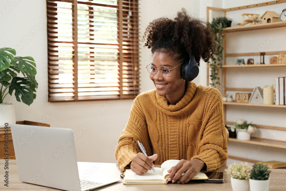 African American teen girl wearing headphones learning language online ...
