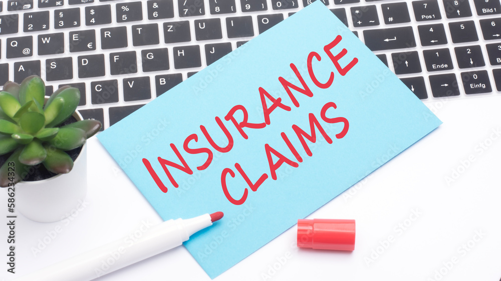 text INSURANCE CLAIMS is written in red marker on a blue card. in the ...