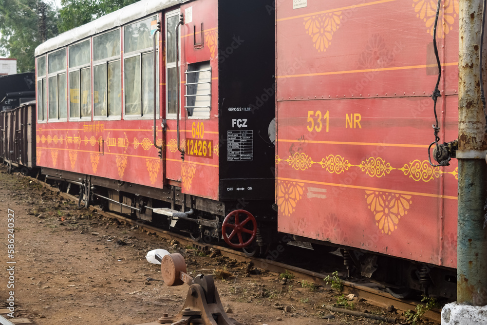 View of Toy train coach from the middle of railway track during daytime ...