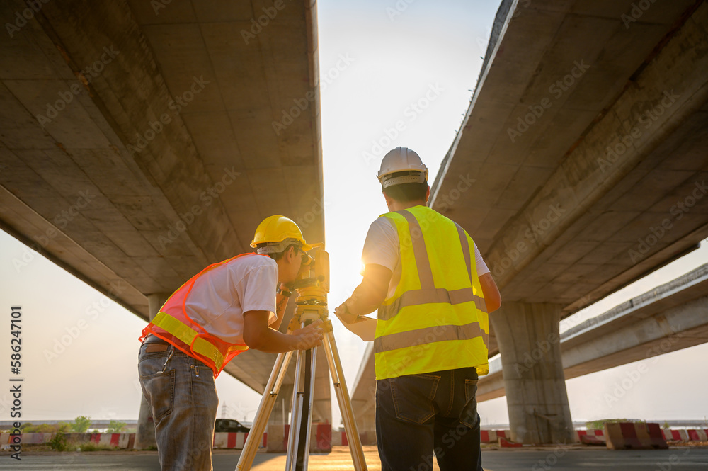 Surveyor Engineer team using theodolite in the construction of a ...
