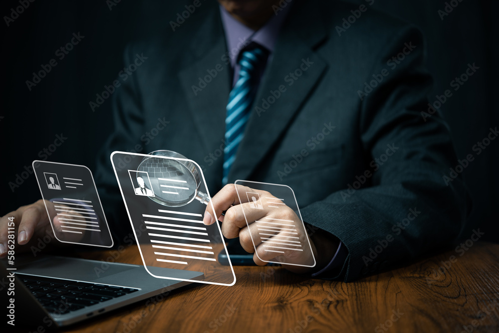 Businessman using Magnifying Glass during with Job Interview Resume ...