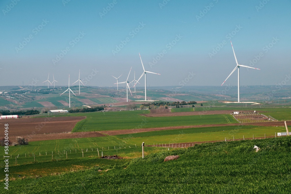Wind turbine and windmill. Clean energy in green nature in different ...